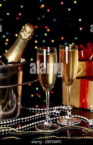 Celebratory champagne with stemware on Christmas lights background ...