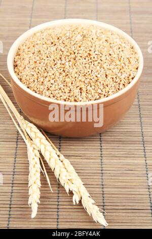 Brown bowl full of wheat bran Stock Photo - Alamy