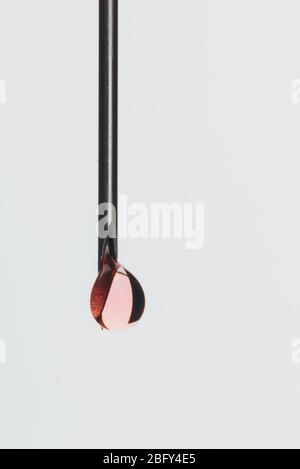 Shooting of syringe needle with drop of blood Stock Photo - Alamy