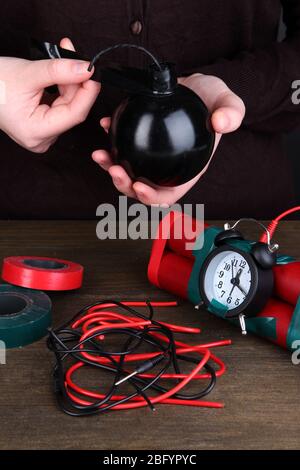 Human makes timebomb on wooden table on black background Stock Photo ...
