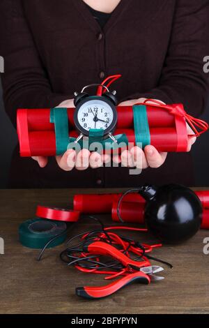 Human makes timebomb on wooden table on black background Stock Photo ...