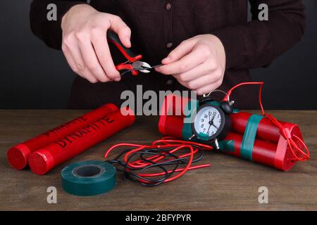 Human makes timebomb on wooden table on black background Stock Photo ...