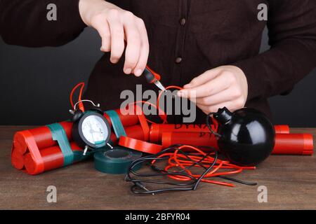 Human makes timebomb on wooden table on black background Stock Photo ...