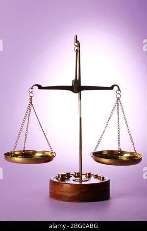 Classic scales on purple background Stock Photo - Alamy