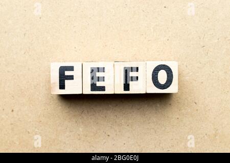 Alphabet letter in word FEFO (first expired first out) on green grass ...