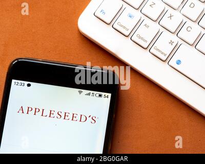 In this photo illustration an Appleseed’s logo seen displayed on a ...