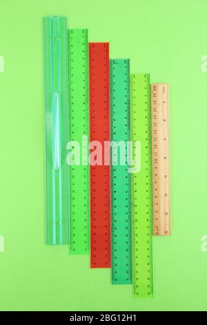 Rulers on green background Stock Photo - Alamy