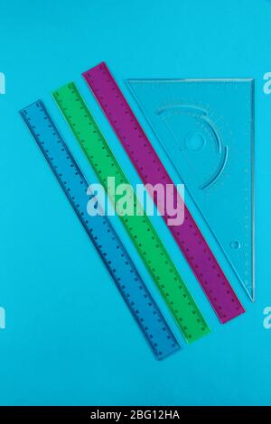 Rulers on blue background Stock Photo - Alamy