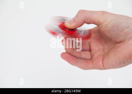 Male hand holding popular fidget spinner toy Stock Photo - Alamy