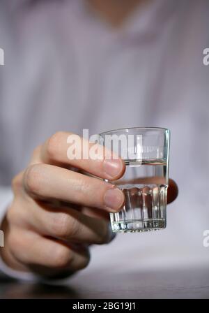 Man hand with glass of vodka , close up Stock Photo - Alamy