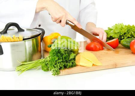 Female hands cutting vegetables, isolated on white Stock Photo - Alamy