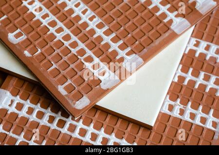 Ceramic tile back side. Three ceramic tiles on a black background. The ...