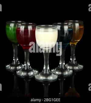 Tasty color liquors, isolated on black Stock Photo - Alamy
