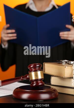 Judge read verdict on orange background Stock Photo - Alamy