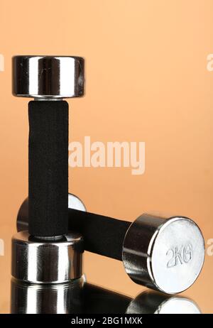 Dumbbells at 2 kg on beige background Stock Photo - Alamy