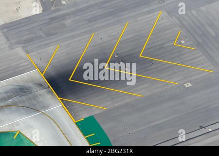 Large yellow sign with directional arrows pointing in multiple ...