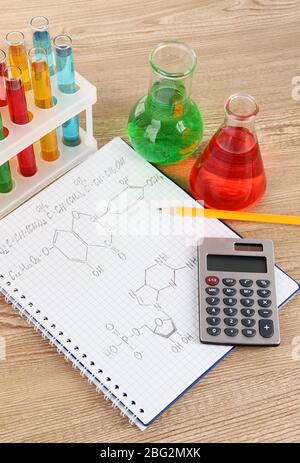 Test tubes with colorful liquids and formulas on grey background Stock ...