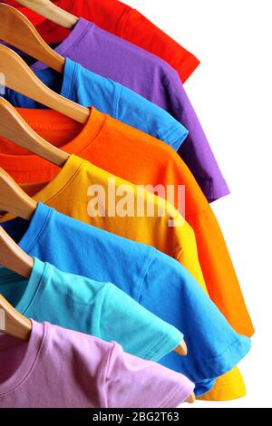 Lots of T-shirts on hangers isolated on white Stock Photo - Alamy