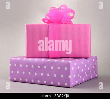 Bright gifts with bows on grey background Stock Photo - Alamy