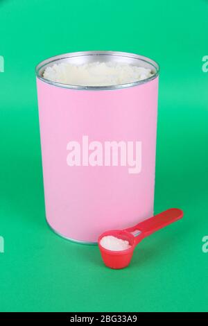 Powdered milk for baby on green background Stock Photo - Alamy