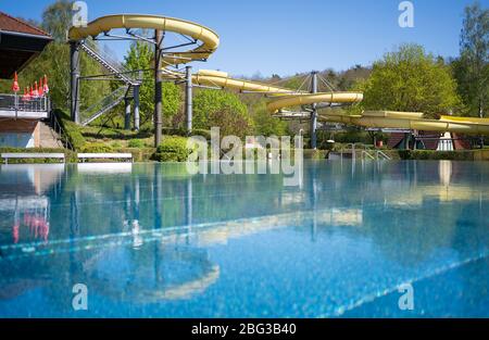 Ebing, Germany. 20th Apr, 2020. The slide of the closed outdoor pool ...