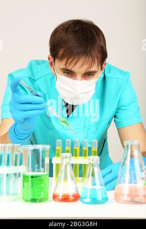 Assayer during research on room background Stock Photo - Alamy
