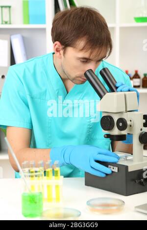 Assayer during research on room background Stock Photo - Alamy