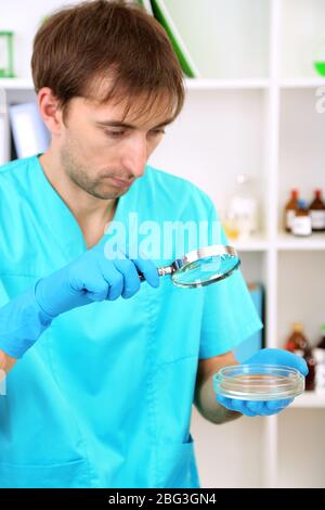 Assayer during research on laboratory background Stock Photo - Alamy