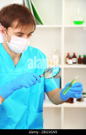 Assayer during research on laboratory background Stock Photo - Alamy