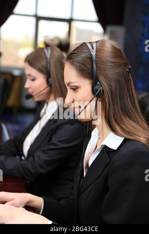 Call center. Group of operators at work. Focus on young brunette woman. Business concept Stock ...