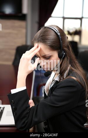 Weary telephone operator Stock Photo - Alamy