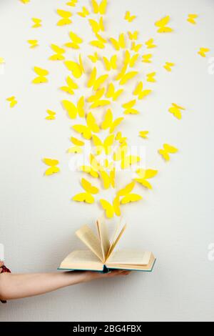Paper yellow butterflies fly out of book Stock Photo - Alamy