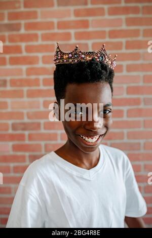 Handsome smiling preteen boy wearing blue t-shirt and beige chef's ...