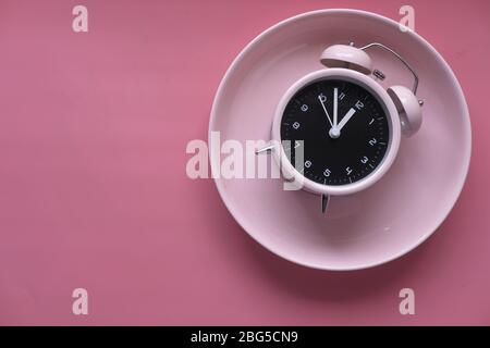 Alarm clock and cutlery on color background. Diet concept Stock Photo ...