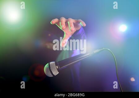Drop the mic concept image. Shot with stage lighting multicoloured ...