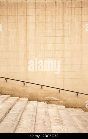 Side view of concrete steps and railing leading to an entrance in a ...