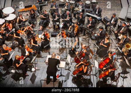 Conductor leading orchestra Stock Photo - Alamy