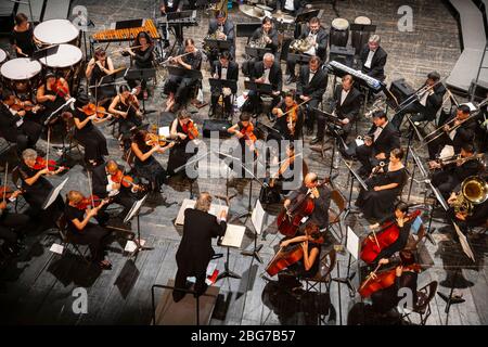 Overhead view of conductor leading orchestra (all model released) in ...