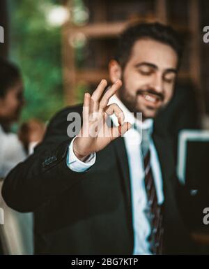 Worker shows hand sign okey Stock Photo - Alamy