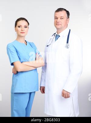 Medical workers on grey background Stock Photo - Alamy