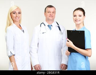 Medical workers on grey background Stock Photo - Alamy