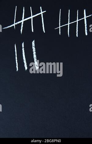 Counting days by drawing sticks with chalk on blackboard, top view ...