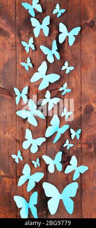 Paper blue butterflies on wooden board background Stock Photo - Alamy