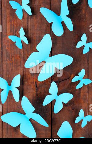 Paper blue butterflies on wooden board background Stock Photo - Alamy