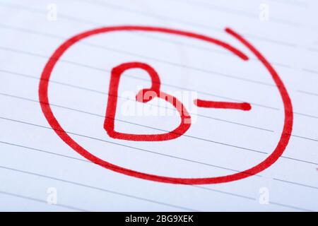 Grade B+ written on an exam paper Stock Photo - Alamy