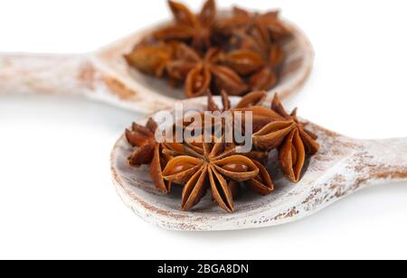 Star anise in wooden spoons, isolated on white Stock Photo - Alamy