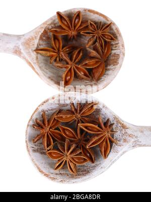 Star anise in wooden spoons, isolated on white Stock Photo - Alamy