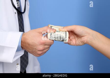 Male Doctor receiving money from patient, isolated on white Stock Photo ...