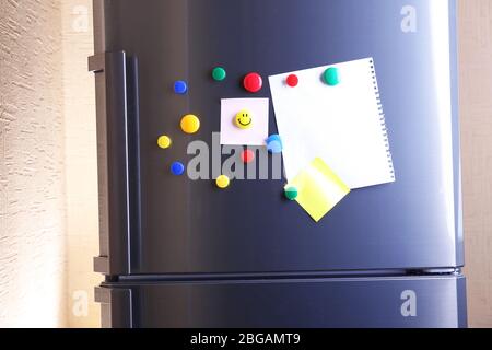 Sheets of paper and magnets on fridge door in kitchen Stock Photo - Alamy