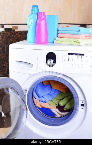 Washing machine loaded with clothes close-up Stock Photo - Alamy